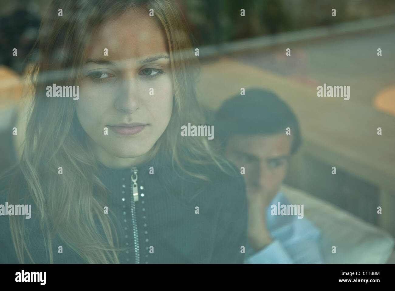 Woman looking through window, portrait Stock Photo - Alamy