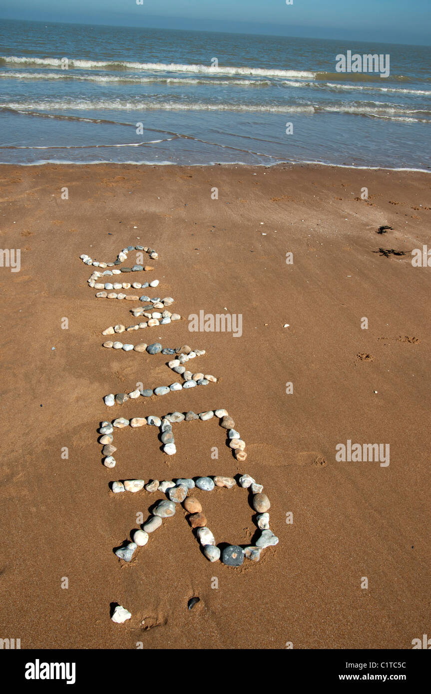 Summer in Stone writing beach sea sand seaside Stock Photo - Alamy