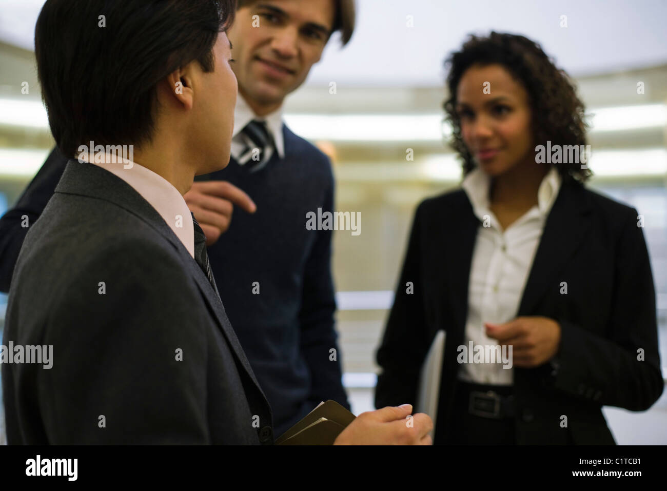 Executive talking to colleagues Stock Photo - Alamy