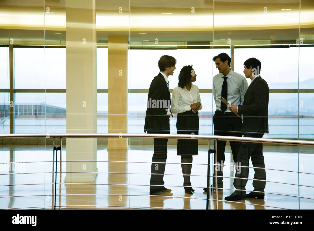 Group of executives talking in corridor Stock Photo - Alamy