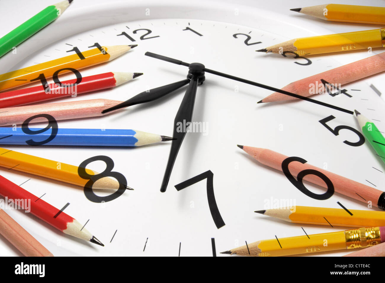 Pencils and Clock Stock Photo - Alamy