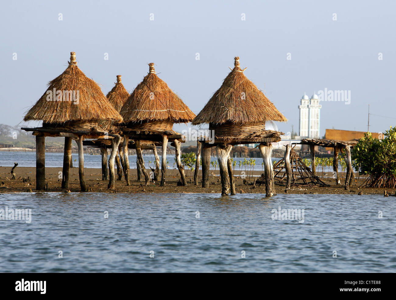Island composed of shells with granaries on stilts out in the sea to ...