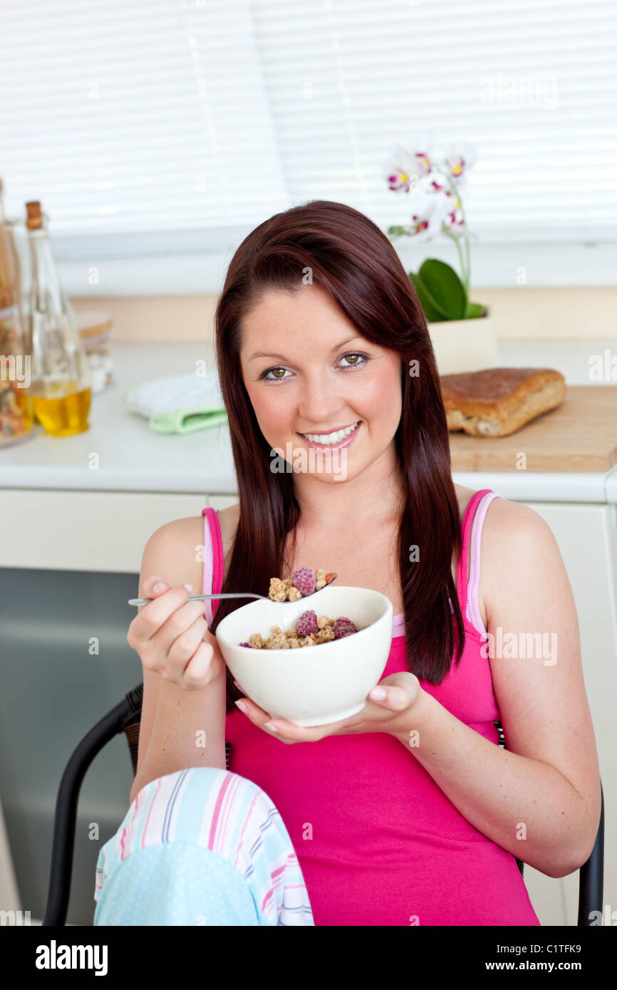 Charming woman eating her breakfast at home Stock Photo - Alamy