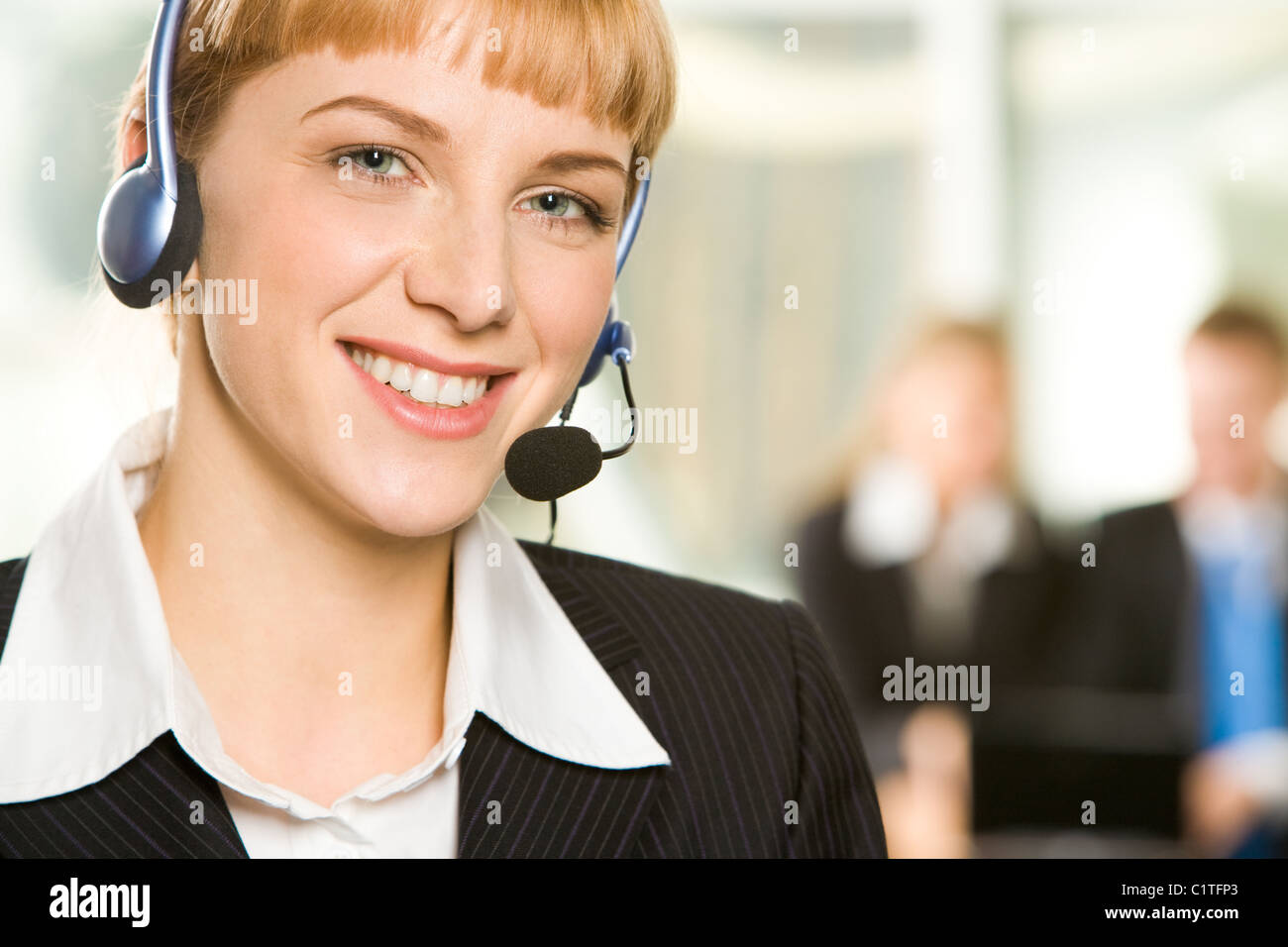Portrait of friendly Customer Support Representative in working ...