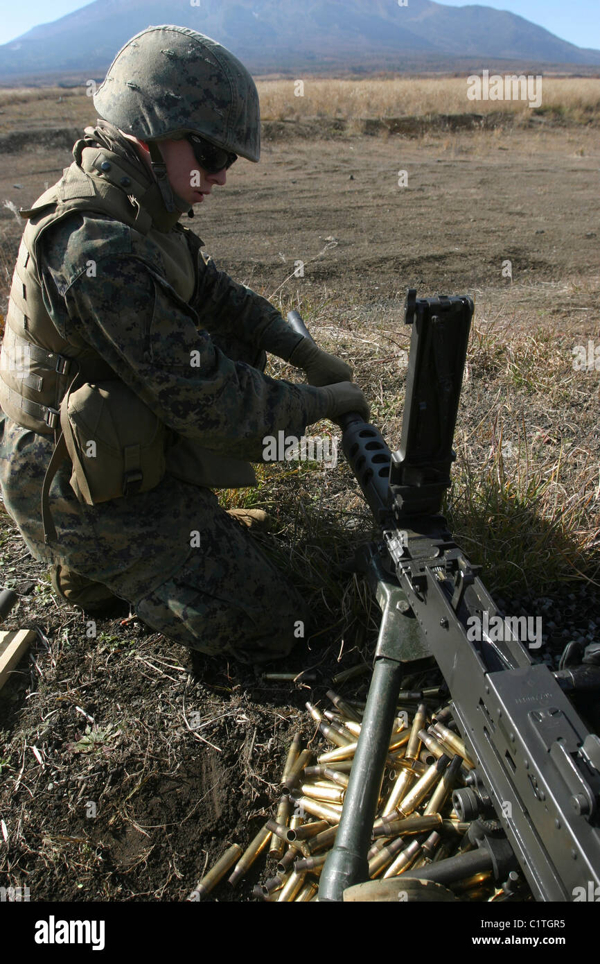 A soldier changes the barrel of an M2 .50 caliber machine gun Stock ...