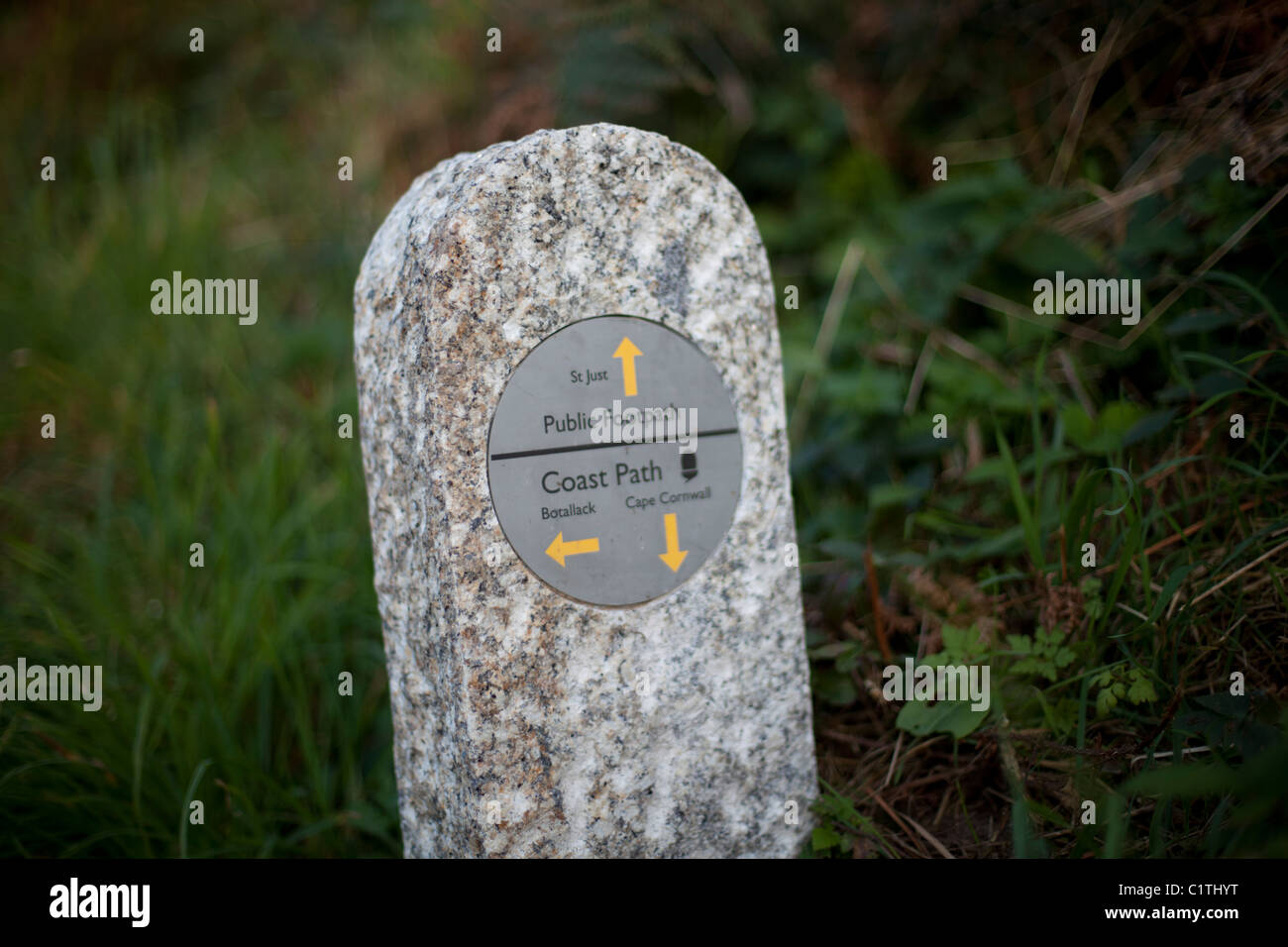 Granite post with directions along coast path Stock Photo - Alamy