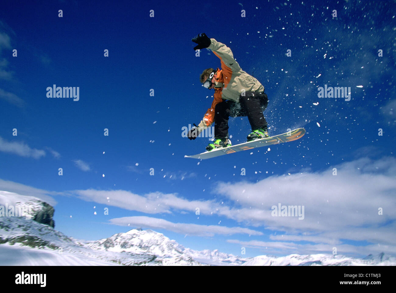Man performing stunt on snowboard Stock Photo - Alamy