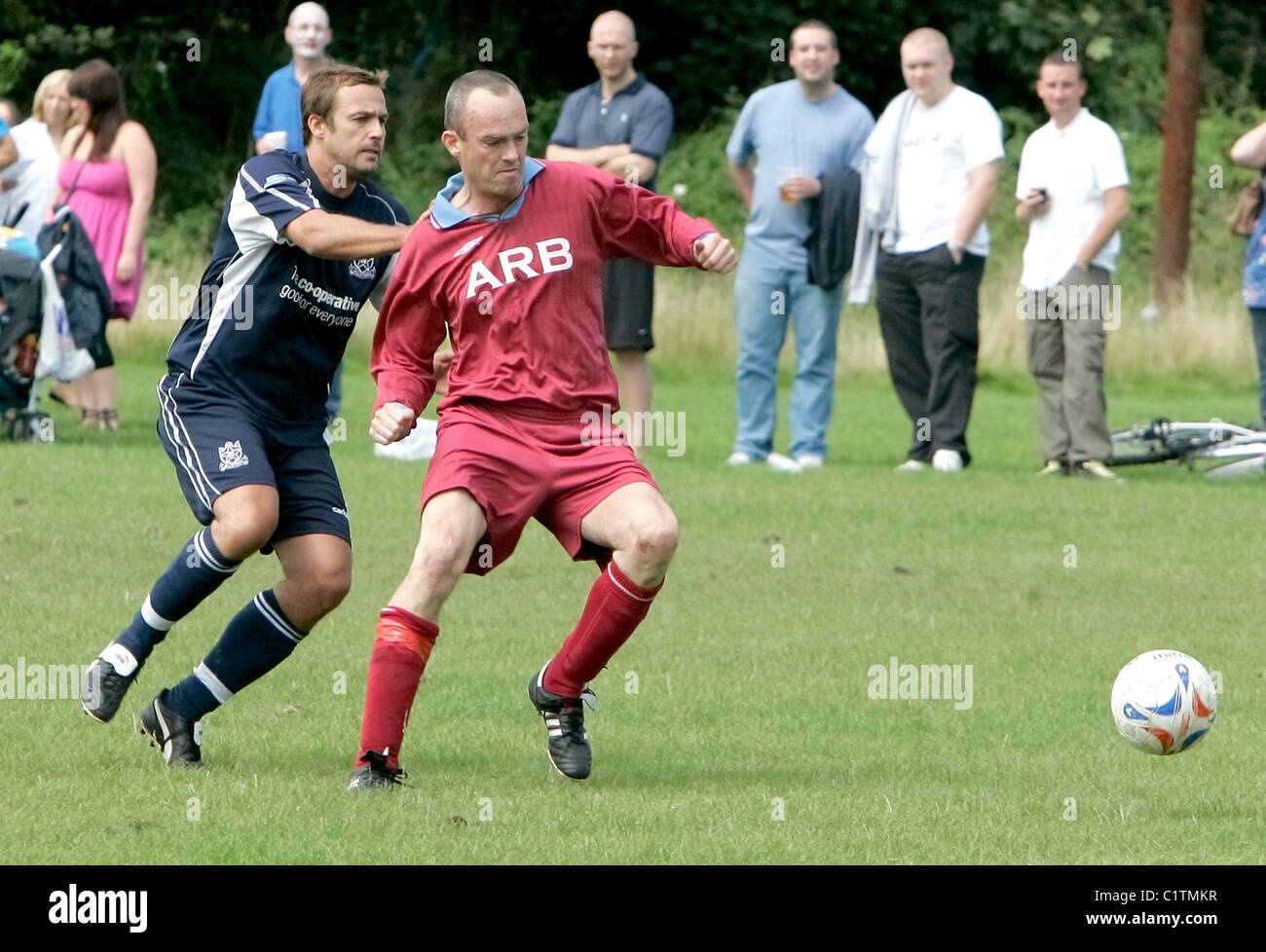 Jamie Lomas of Hollyoaks (left), playing at a charity football match ...