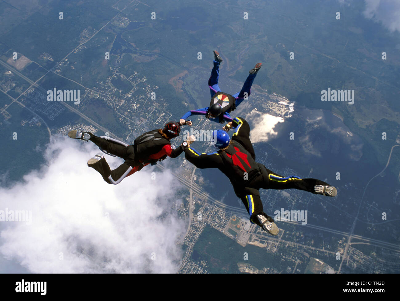Three people skydiving Stock Photo - Alamy