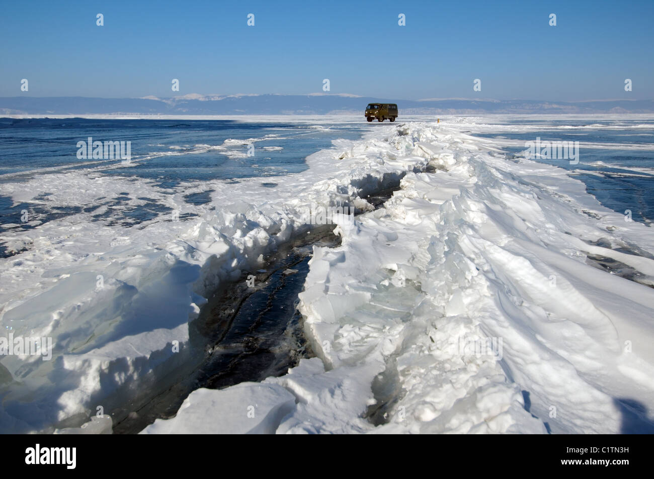 Off-roader crosses the ice crack. lake Baikal, Siberia, Russia, island ...