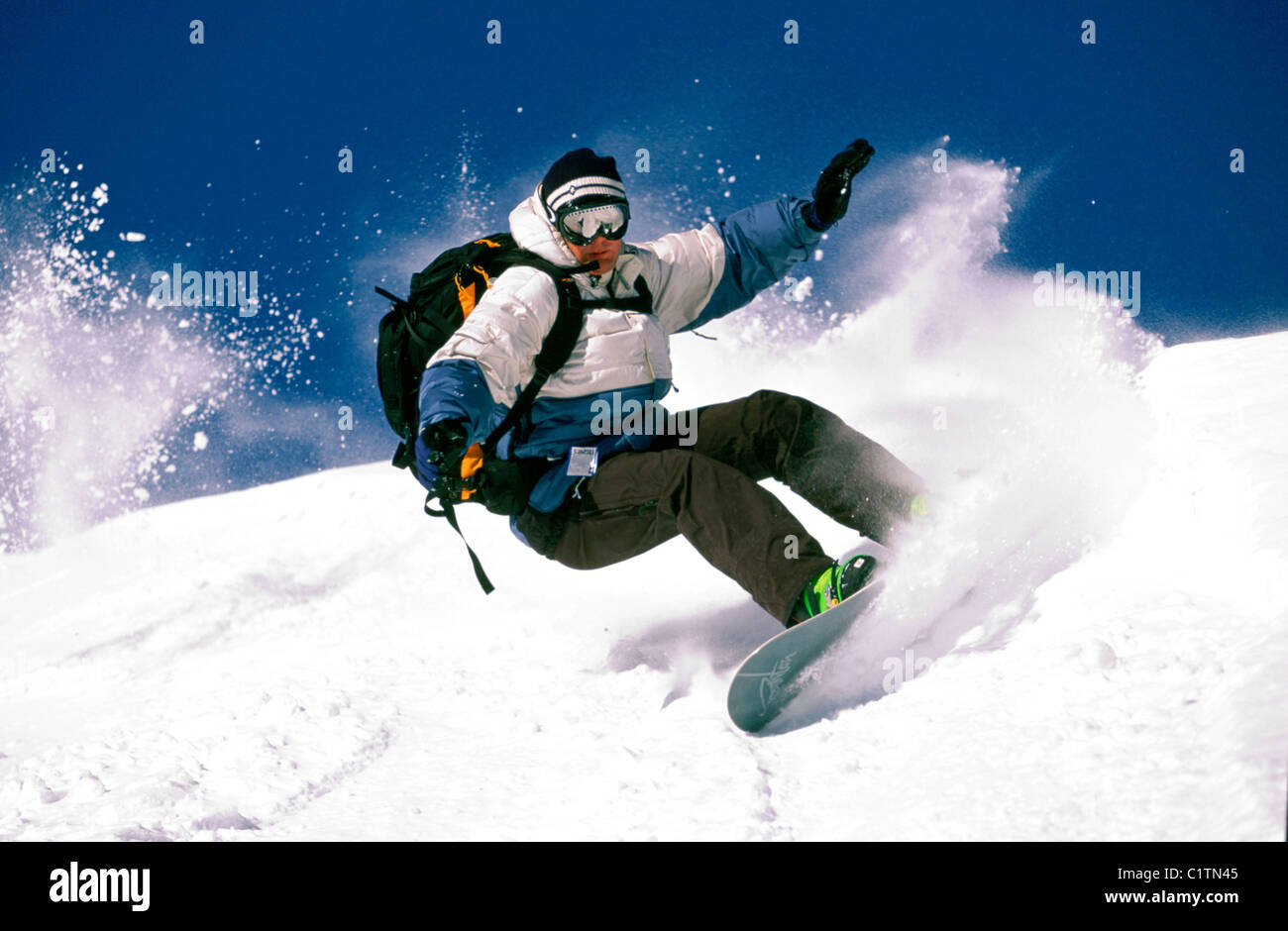 Young adult man sliding down hill Stock Photo - Alamy