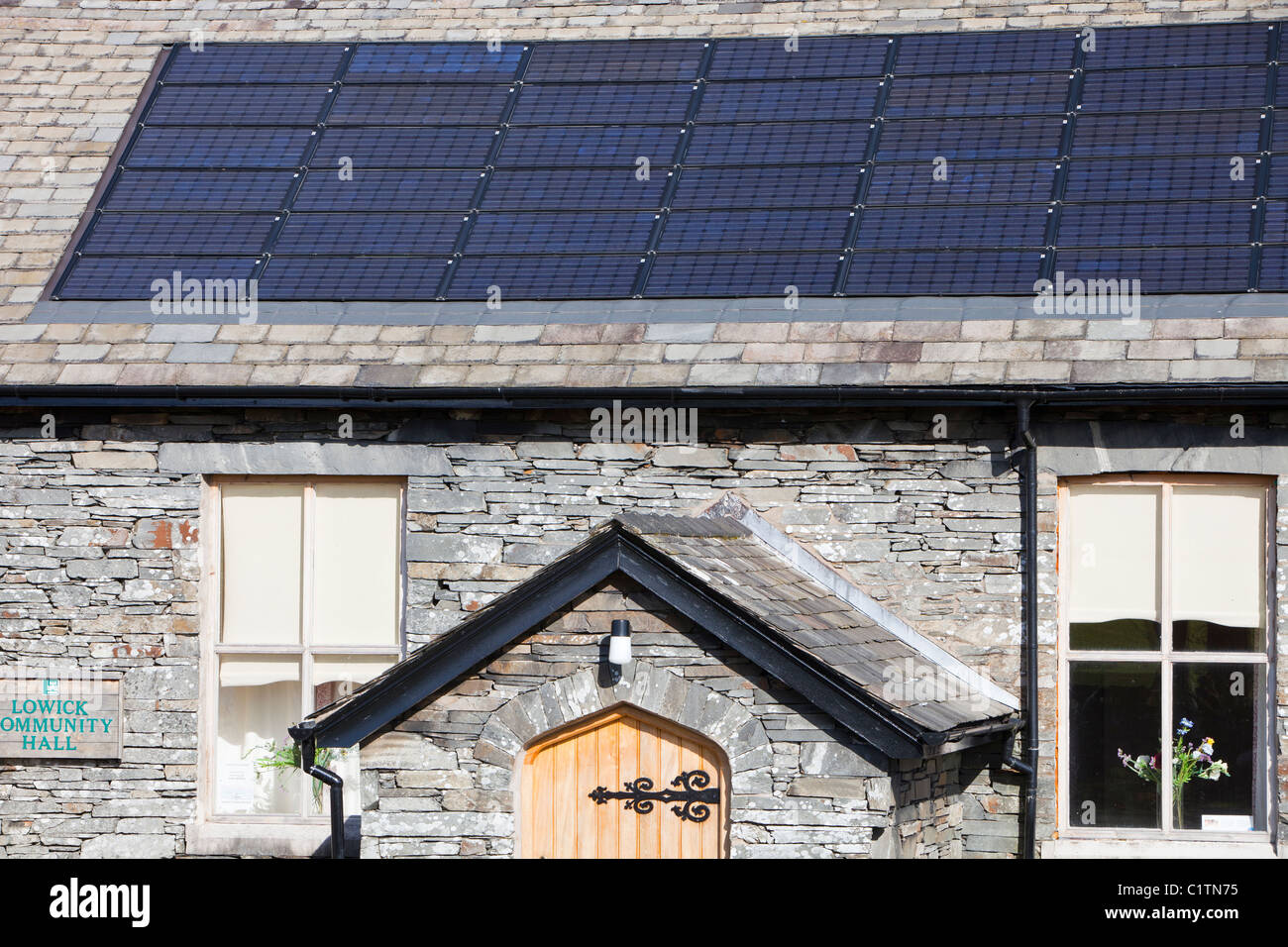 Solar electric panels on Lowick Village Hall in South Cumbria, UK Stock ...
