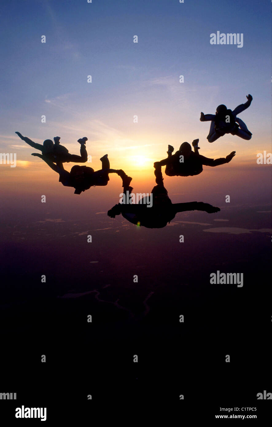Silhouette of five people skydiving Stock Photo - Alamy