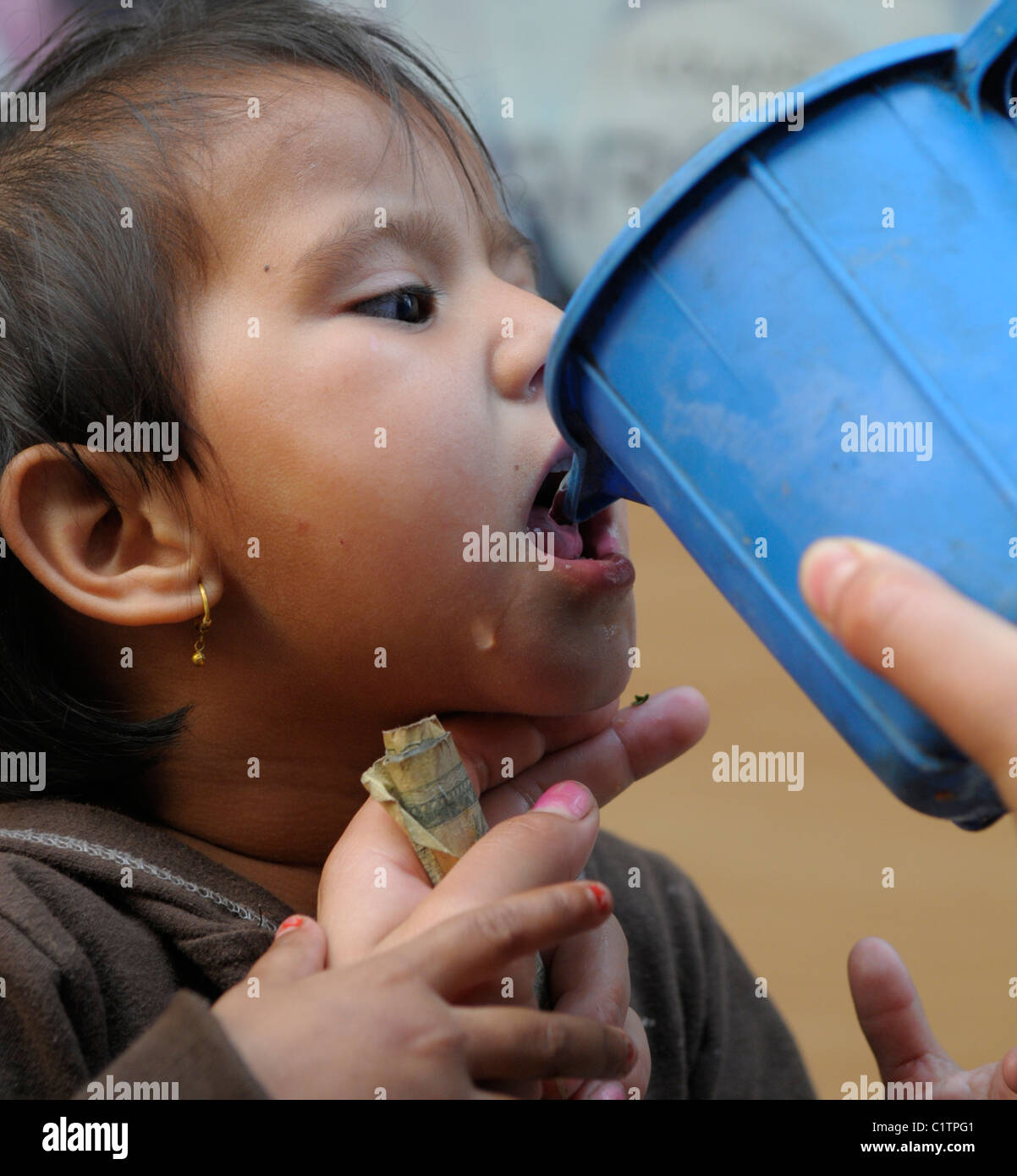 little girl drinking water during festival, the nepalis , life in ...
