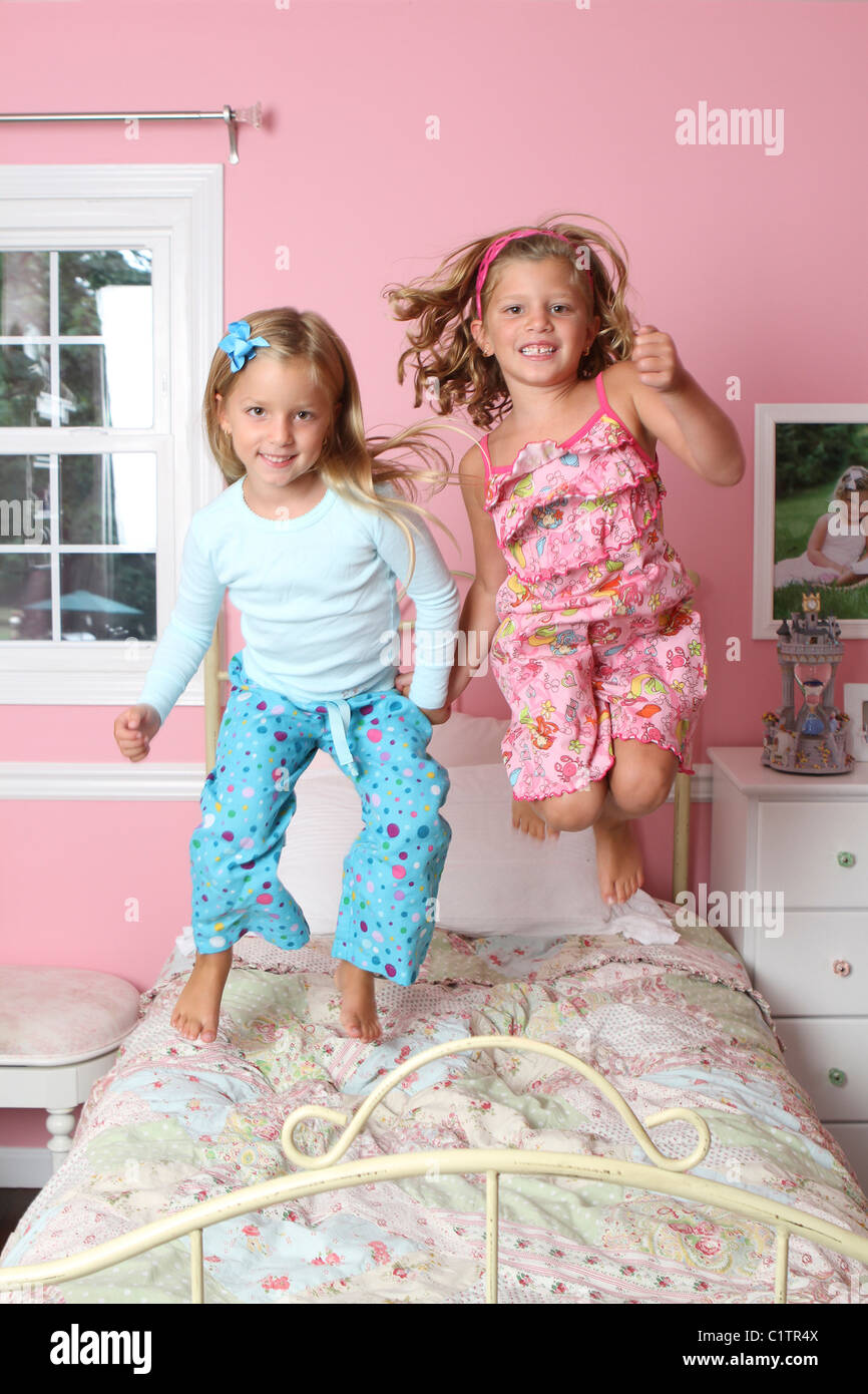 Girls jumping on the bed Stock Photo - Alamy