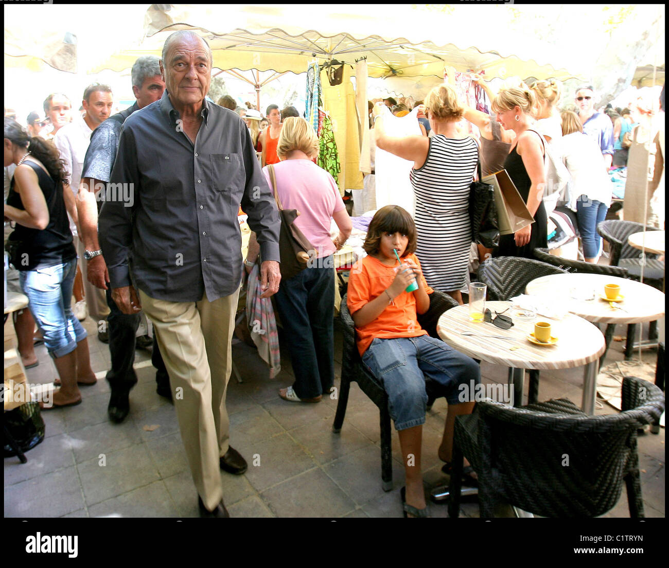 Former French president Jacques Chirac visits a market with friends ...