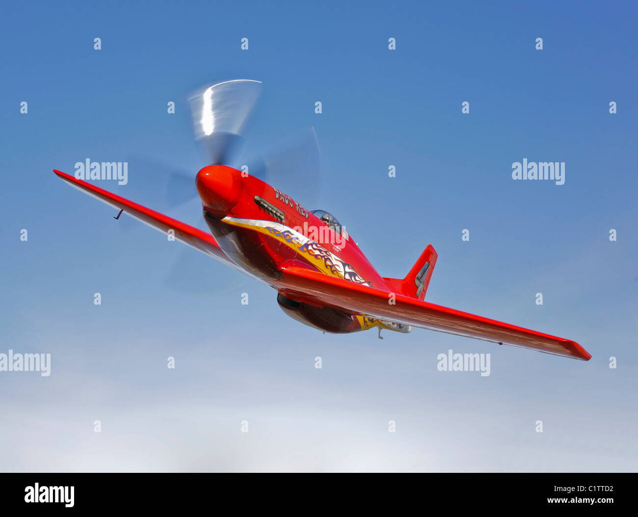 A Dago Red P-51G Mustang modified for competitive air racing, in flight over Hollister ...