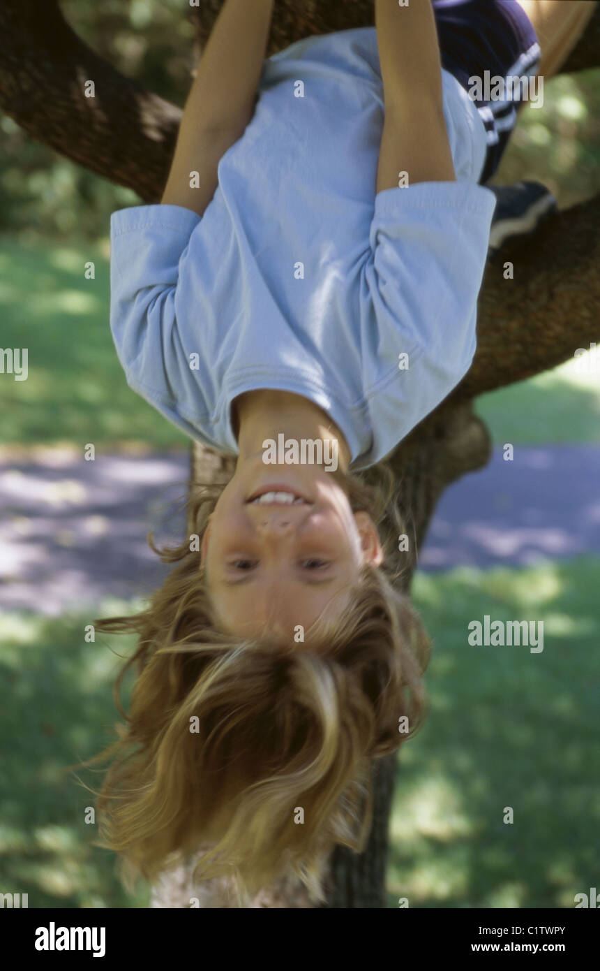 Girl hanging from a tree Stock Photo - Alamy