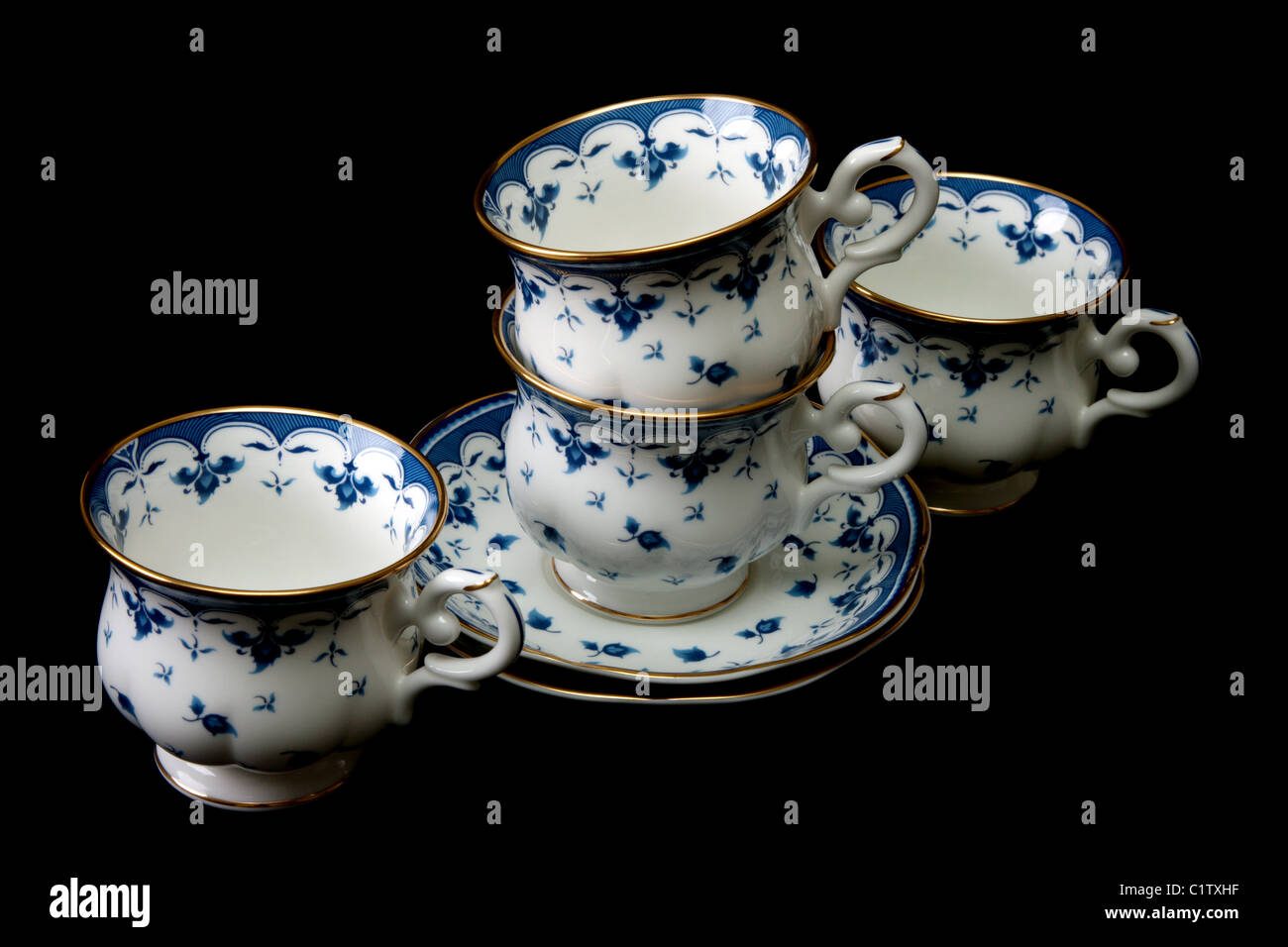 Four tea cups on saucer insulated on white background Stock Photo - Alamy