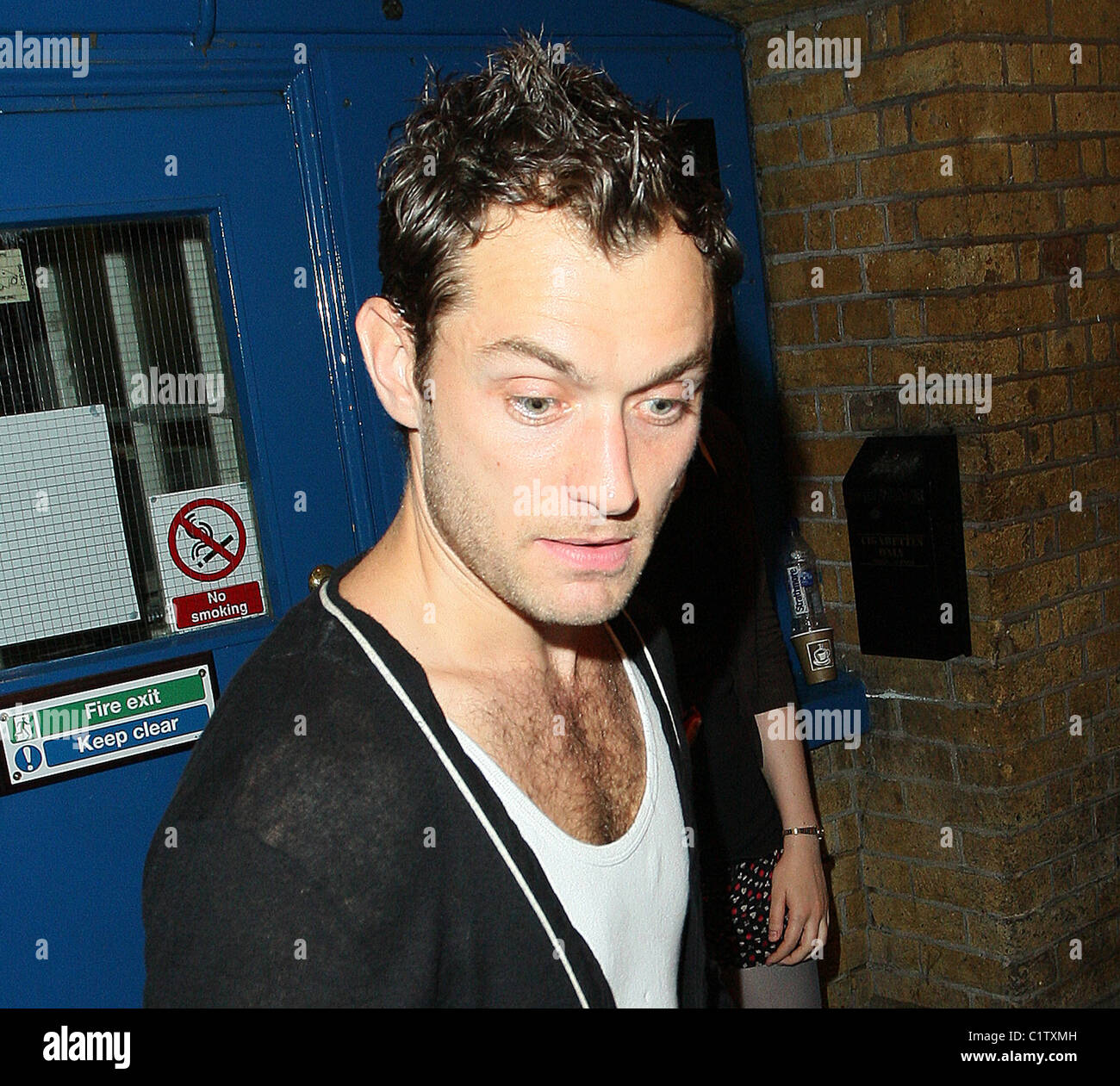 Jude Law signs autographs for waiting fans as he leaves the Wyndham's ...