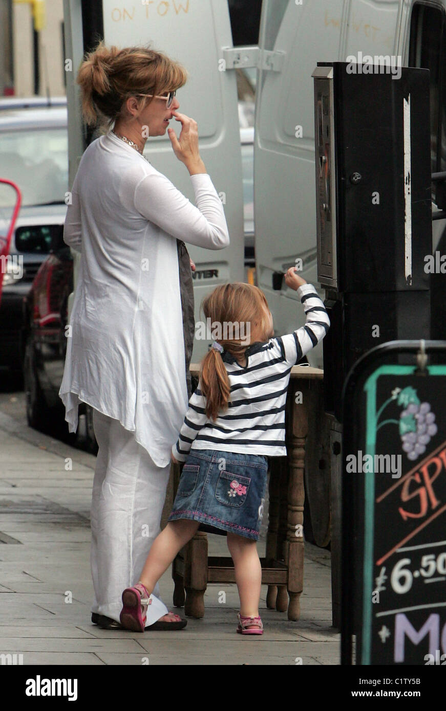 Kate Garraway and her daughter Darcy checks a parking meter for parking ...
