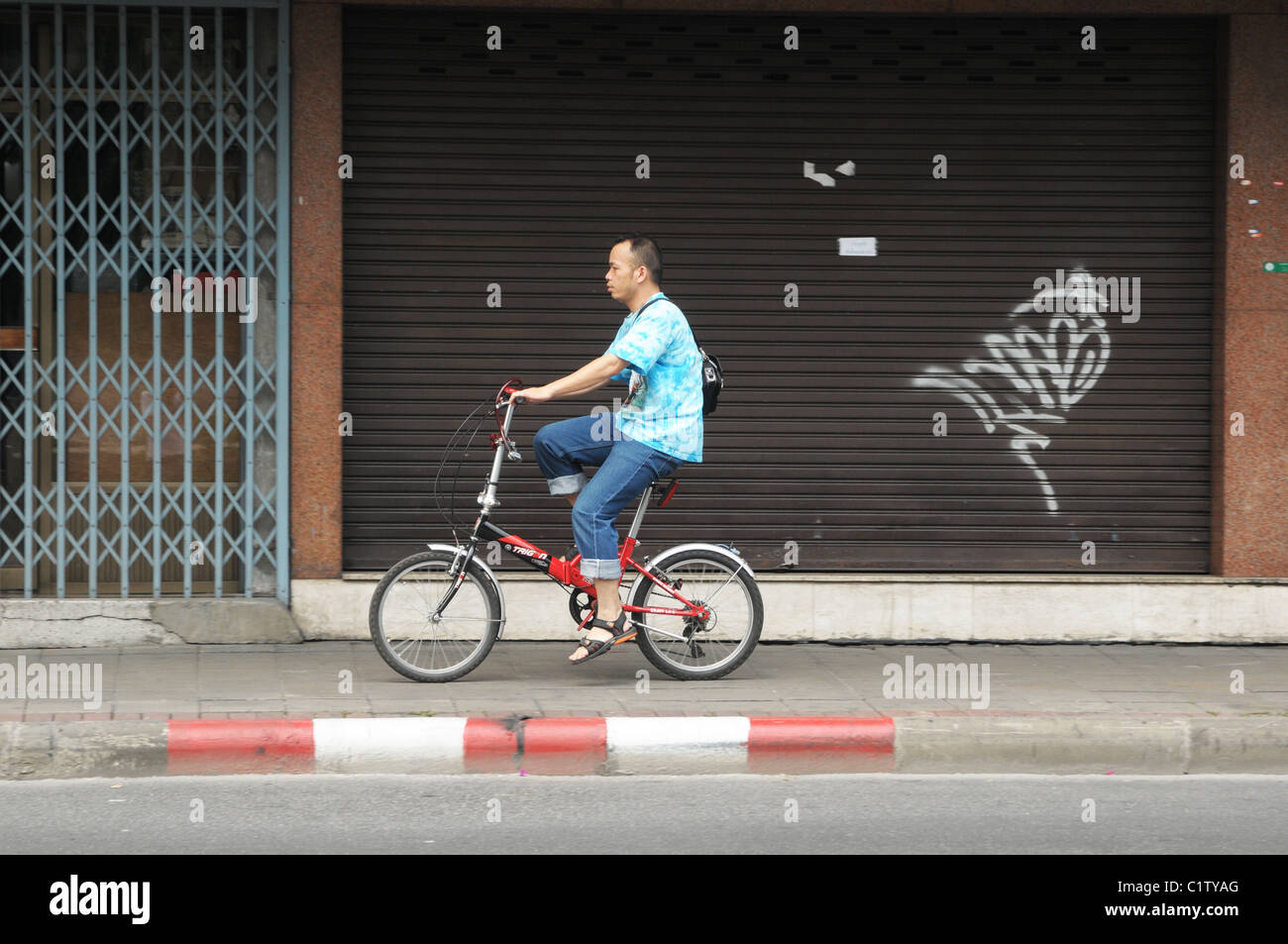 early morning cycle ride on the pavement, chinatown, bangkok, thailand ...
