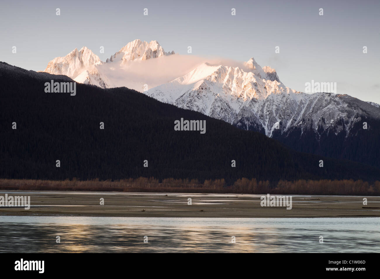 Sunrise creates alpenglow on the Chilkat Mountains and Chilkat River ...