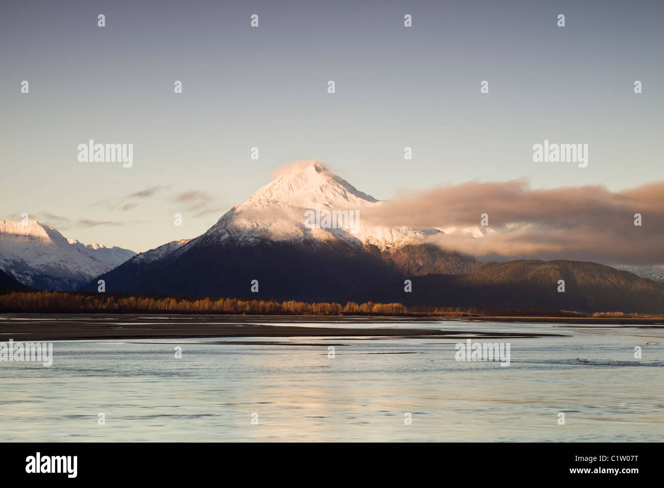 Sunrise creates alpenglow on the Chilkat Mountains and Chilkat River ...