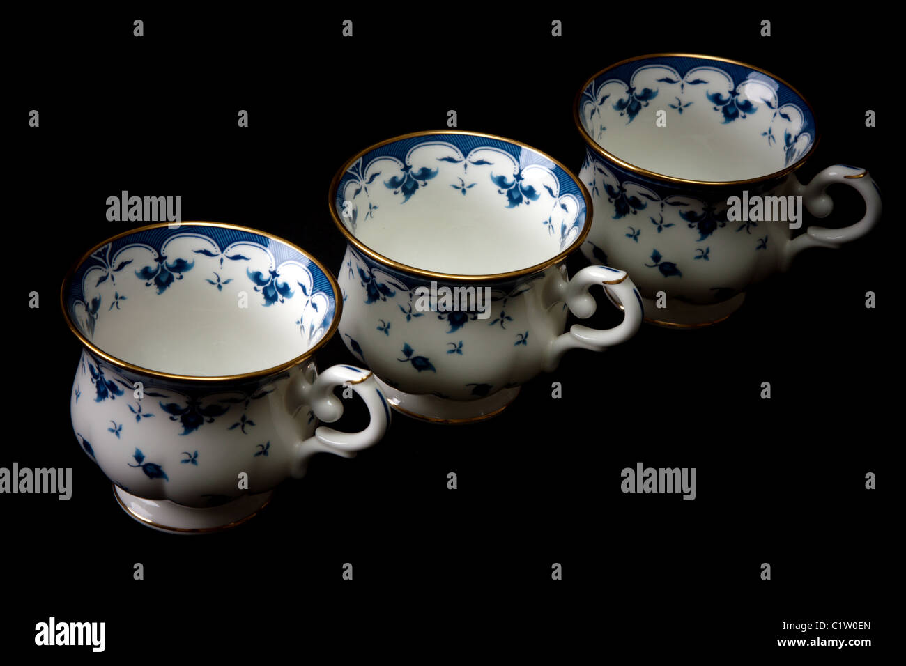 Three tea cups on saucer insulated on white background Stock Photo - Alamy