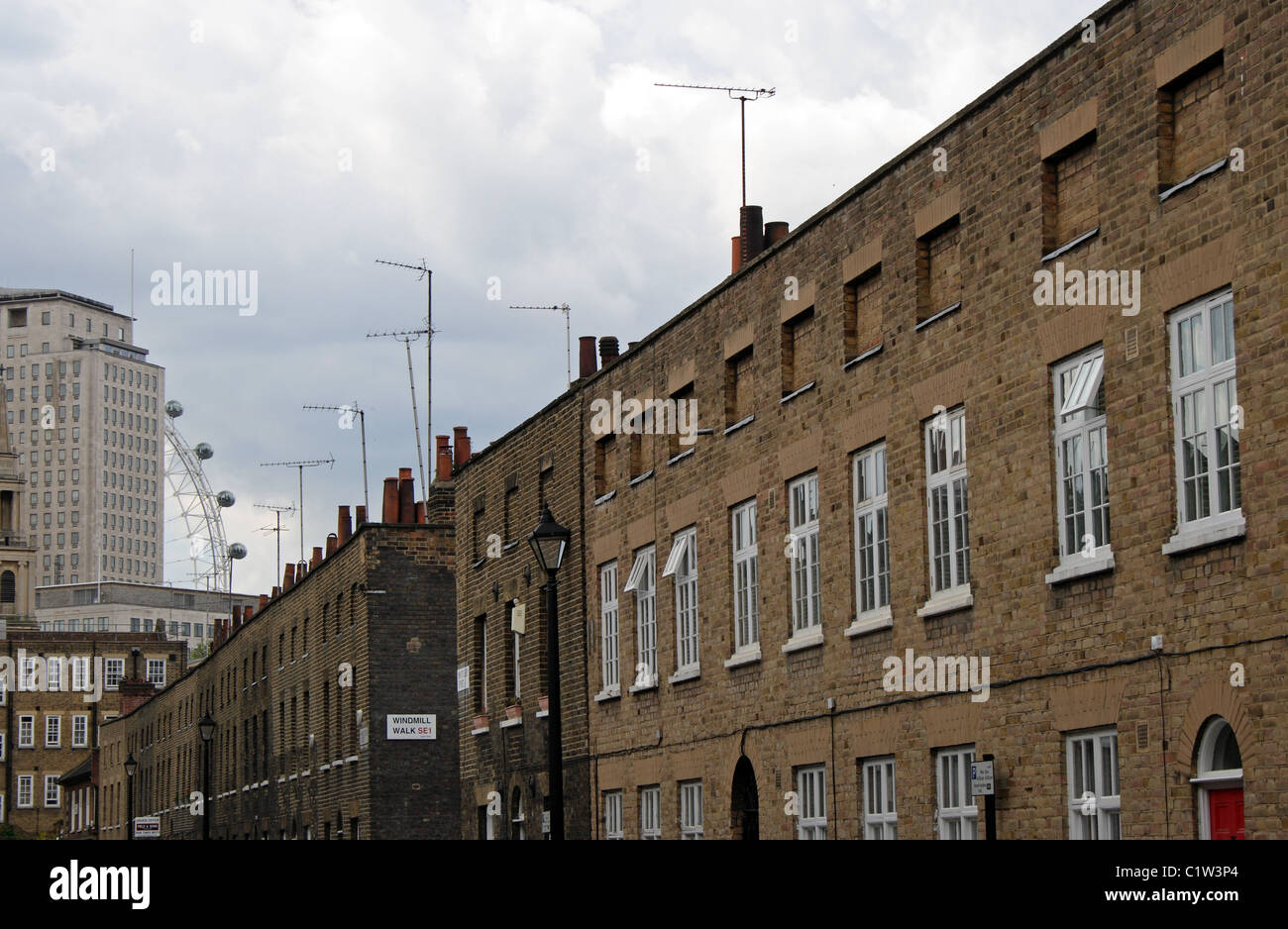 A terraced street in South London, England with the London Eye in the ...