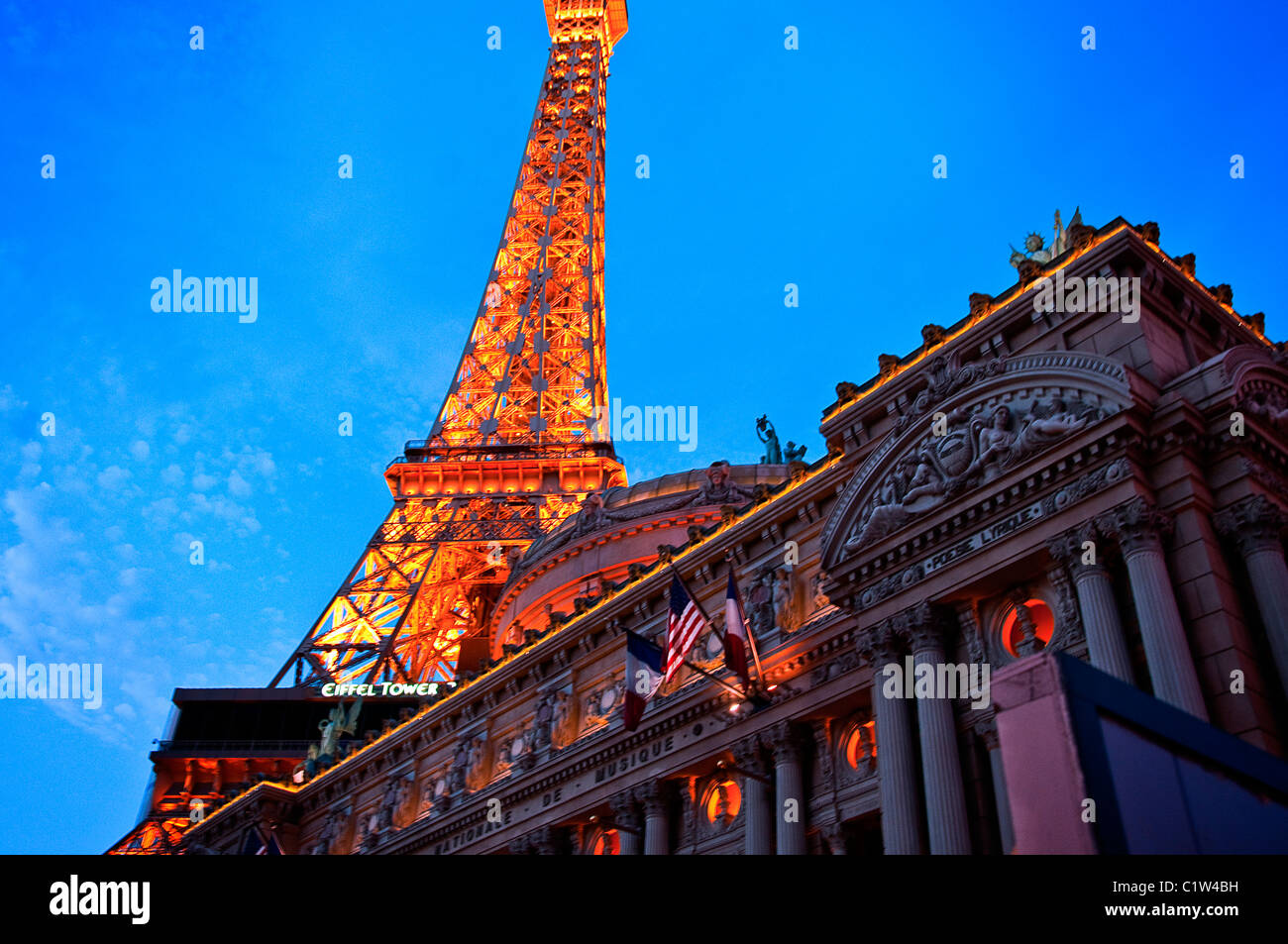 Low angle view of a hotel and the replica of Eiffel Tower lit up at dusk, Paris Las Vegas, The ...