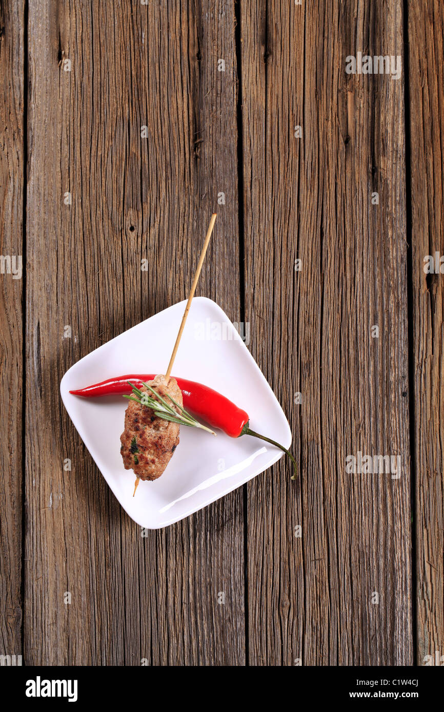 Minced meat kebab on a stick - overhead Stock Photo - Alamy