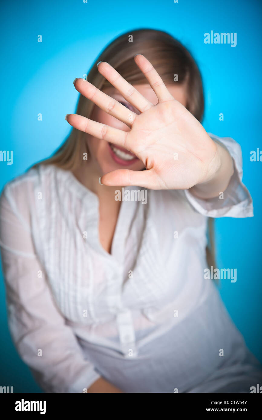 Woman covers herself with hand Stock Photo - Alamy