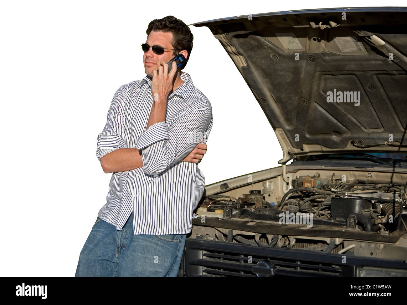 A man calls for help on a cell phone from a stranded car Stock Photo ...