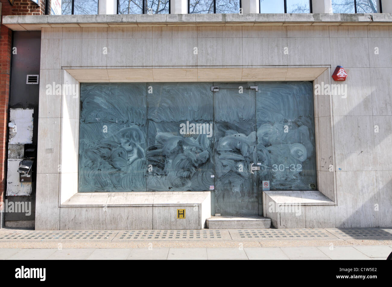 Empty shop with whitewash on the windows Stock Photo - Alamy