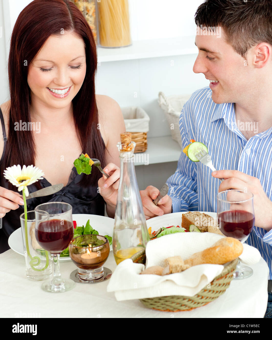 Young couple having dinner at home Stock Photo - Alamy