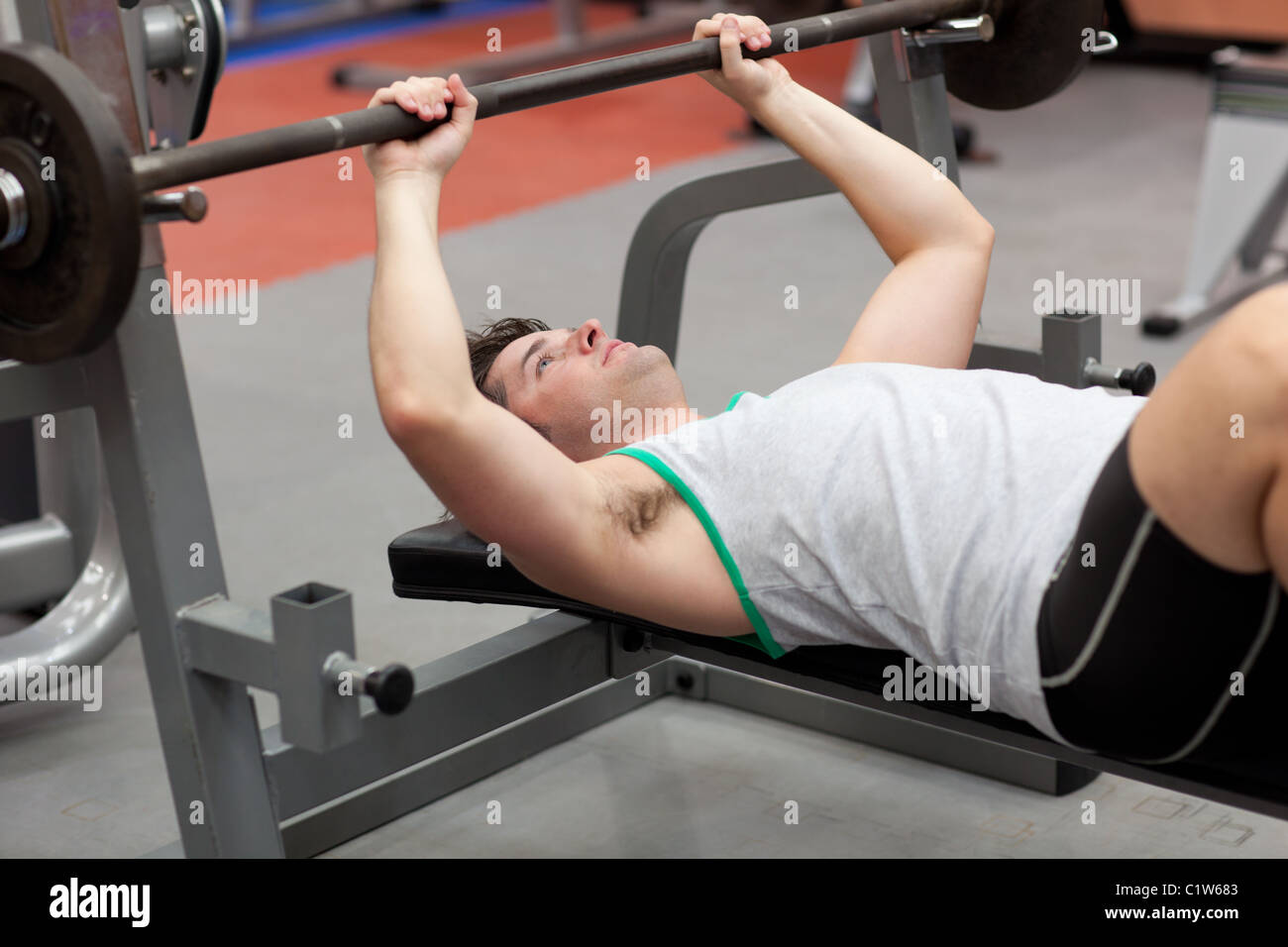 Strong man working out with dumbbells Stock Photo - Alamy