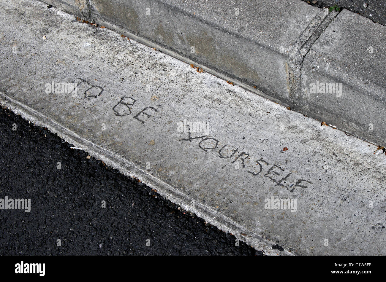 'To Be Yourself', written in concrete Stock Photo - Alamy