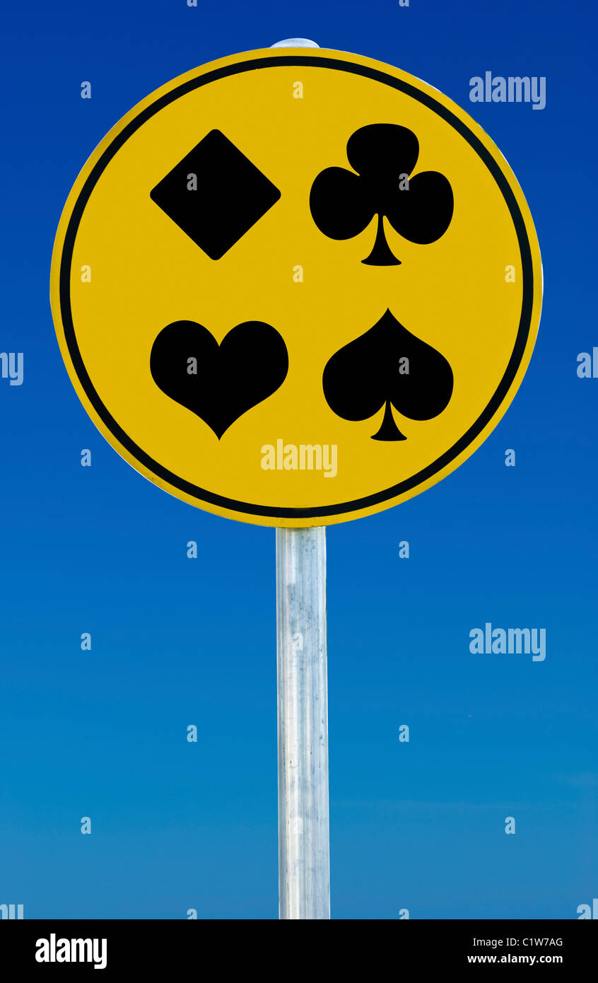 the 4 card suits (Hearts, Diamonds, Clubs and Spades) on a yellow sign ...