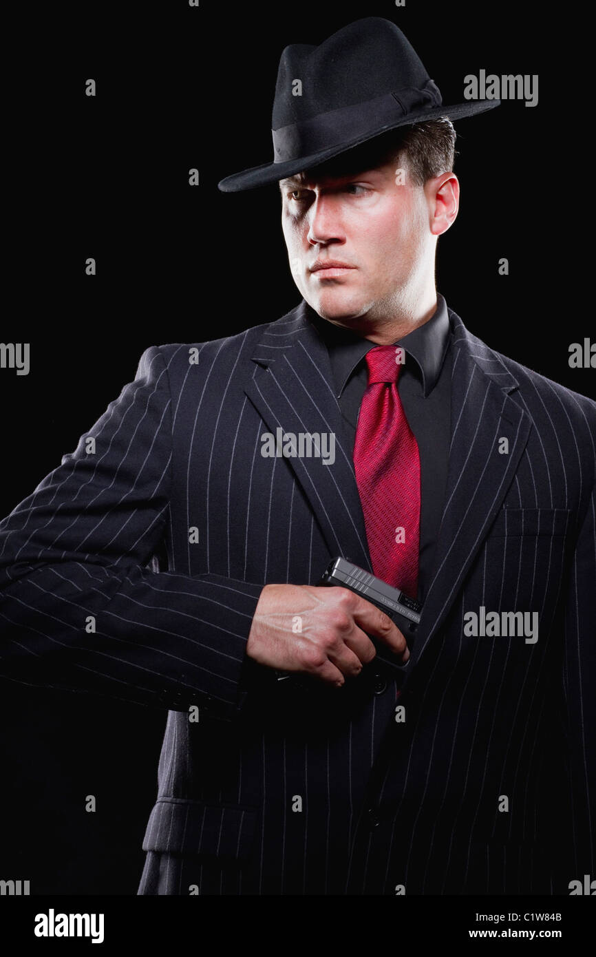 Businessman taking out a gun Stock Photo - Alamy
