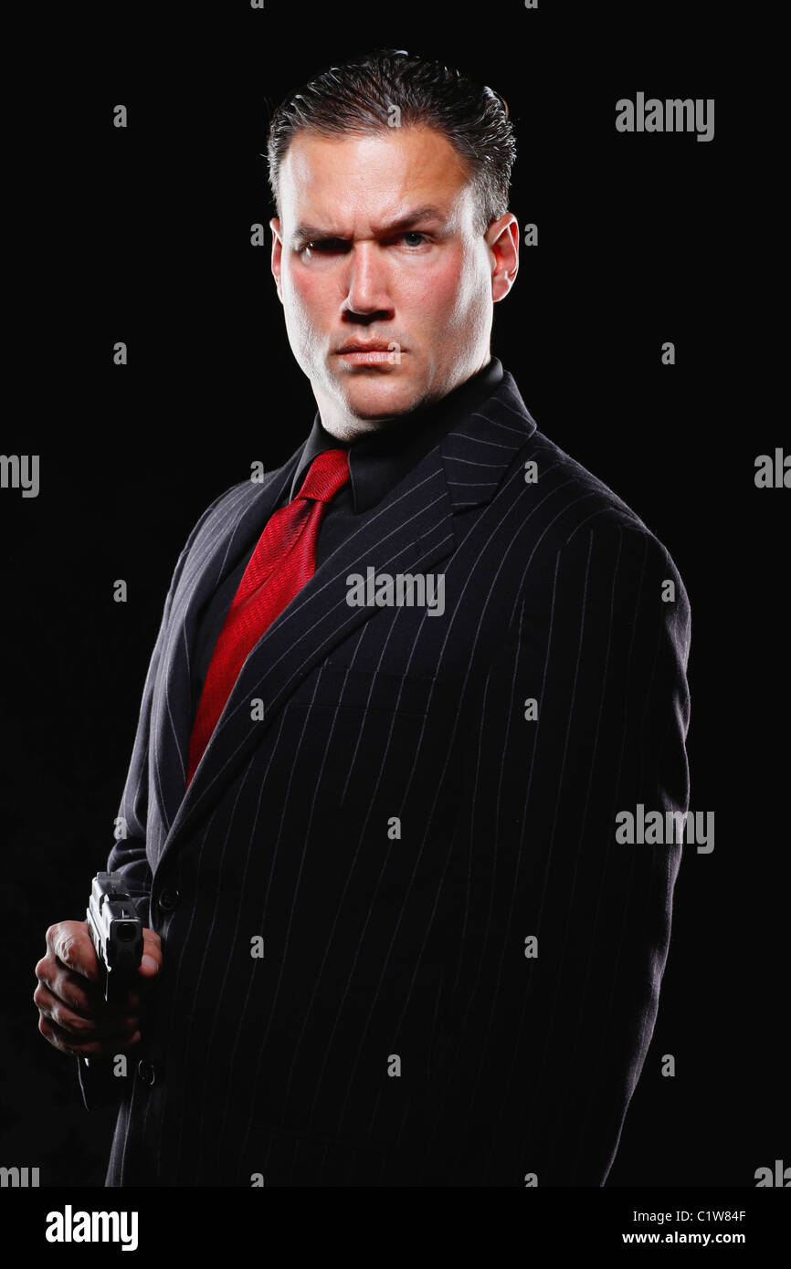 Businessman aiming with a gun Stock Photo - Alamy
