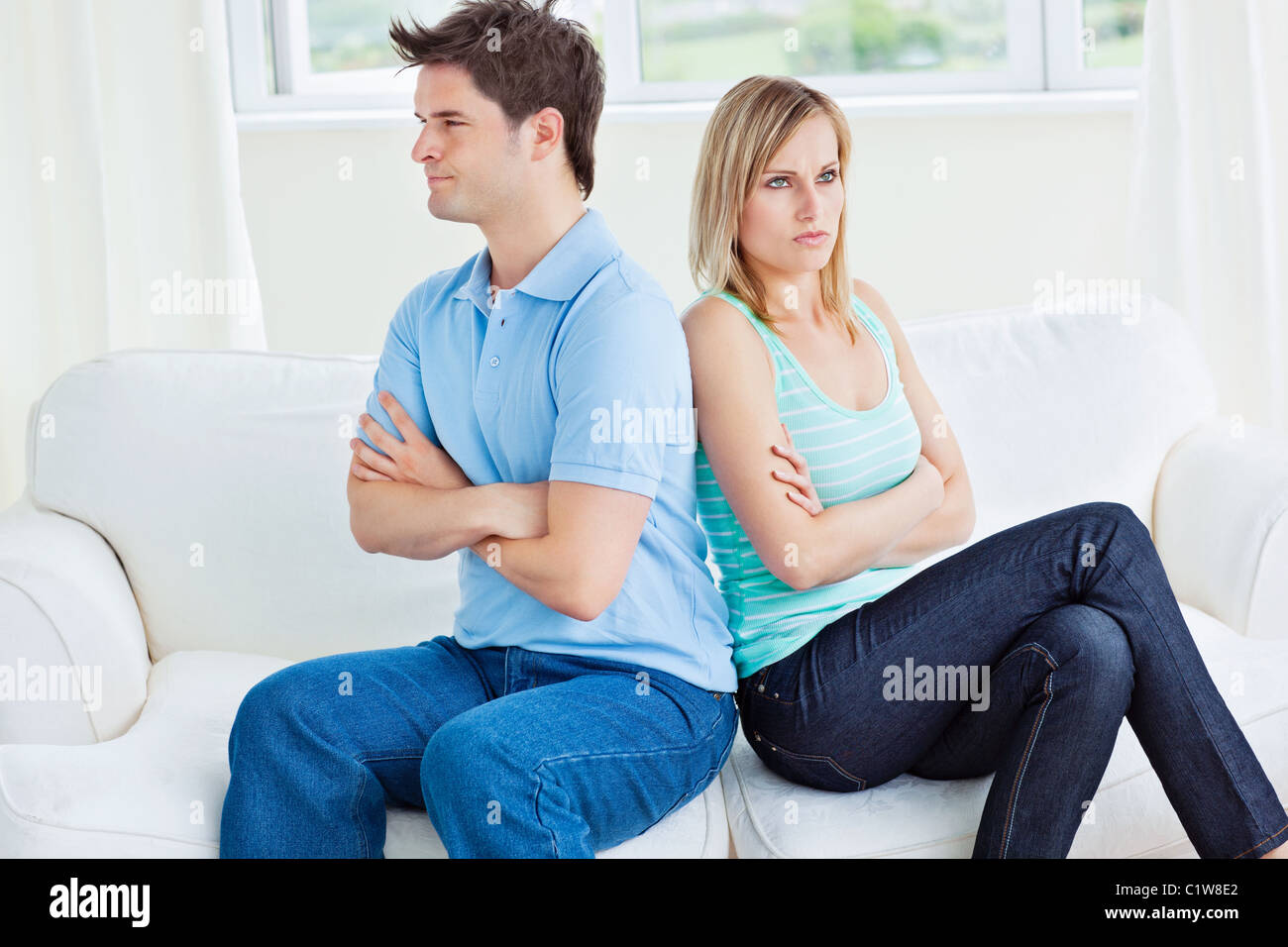 Young Couple Sulking After A Conversation Sitting Back To Back Stock