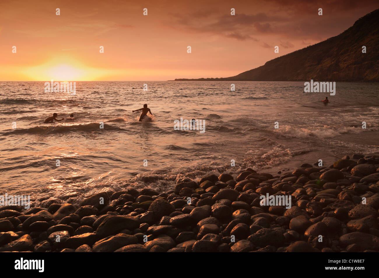 Hawaii, people swimming in sea at sunset Stock Photo - Alamy