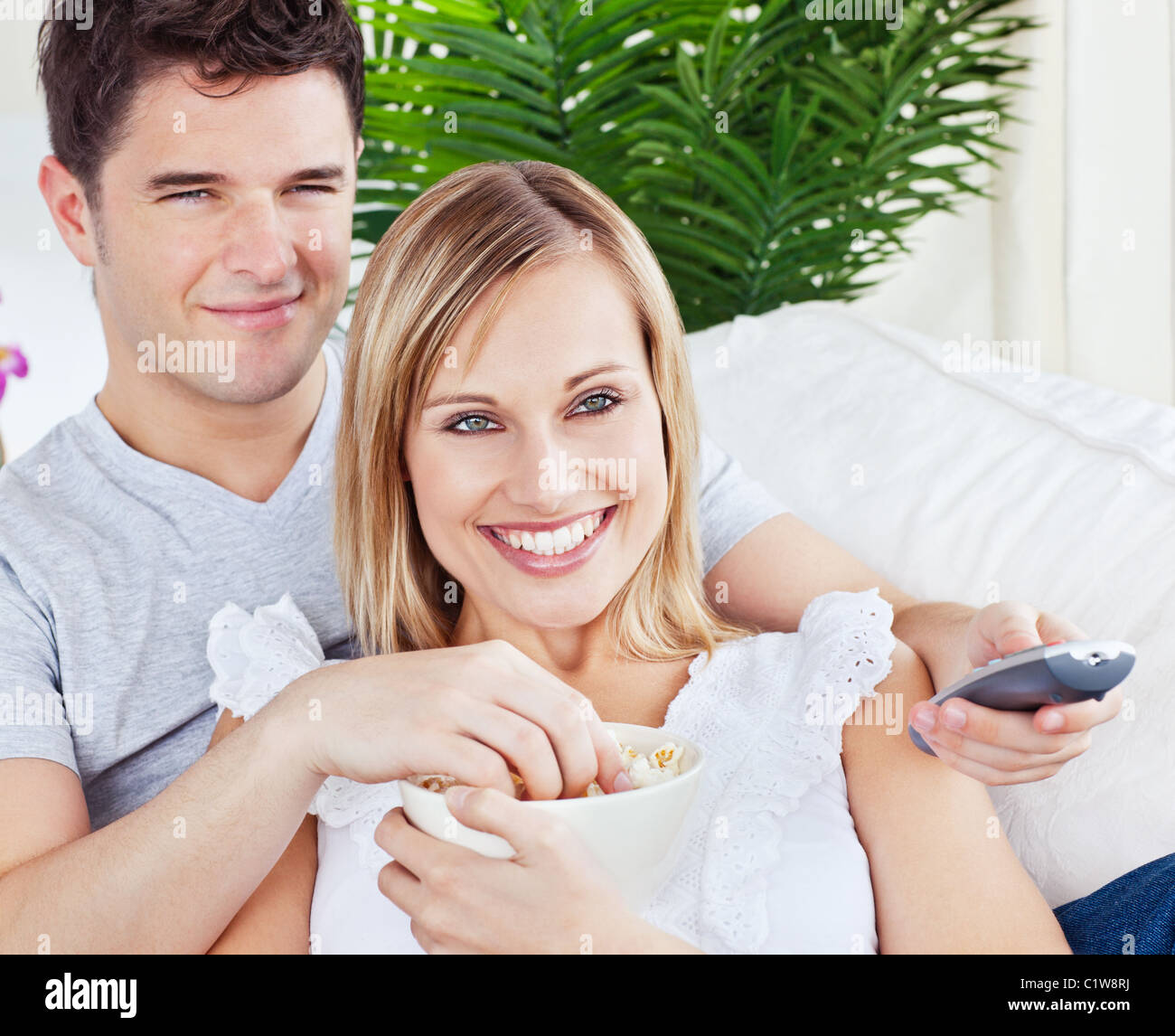 Young couple having fun in front of the TV Stock Photo - Alamy