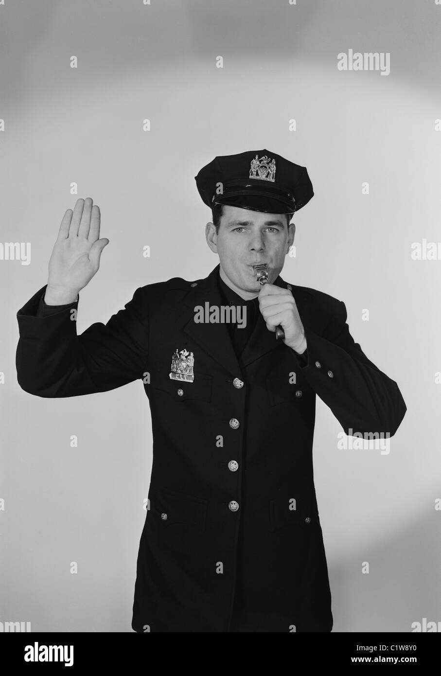 Portrait of young police officer using whistle Stock Photo - Alamy