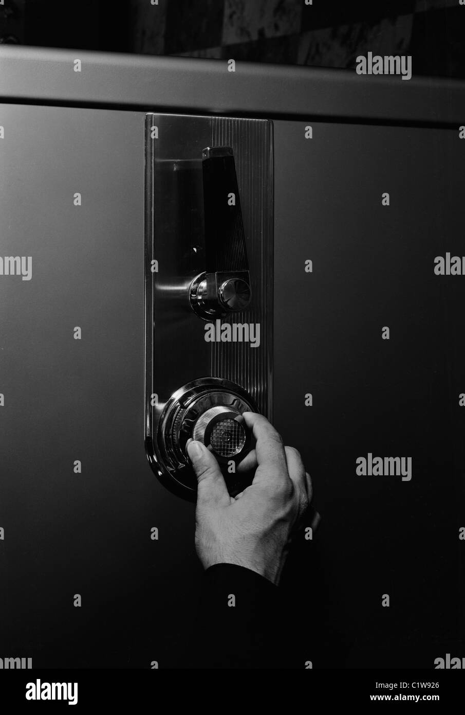 Hand unlocking safe Stock Photo - Alamy