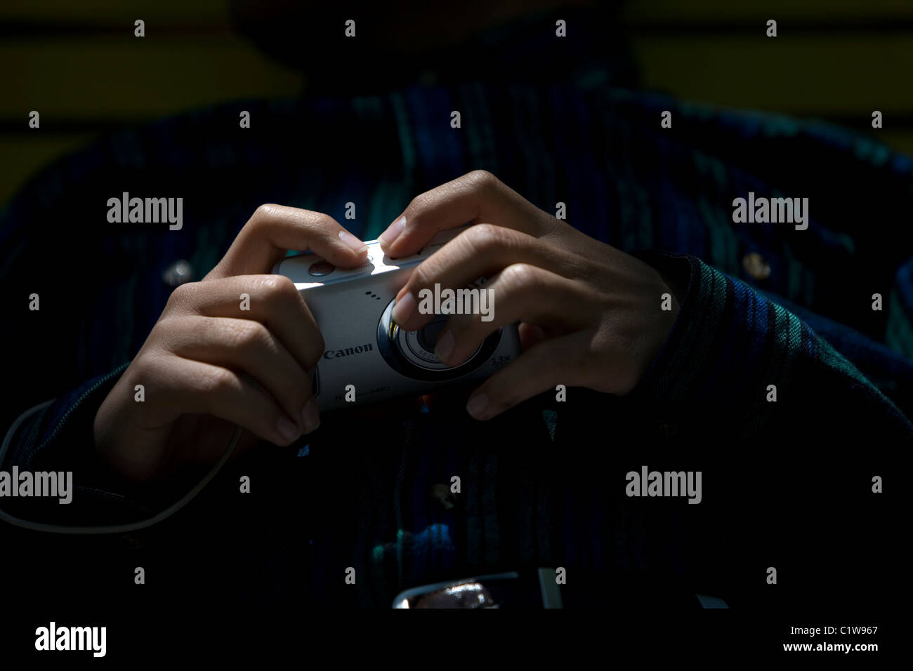 A blind male student touches a camera during a photography workshop for ...