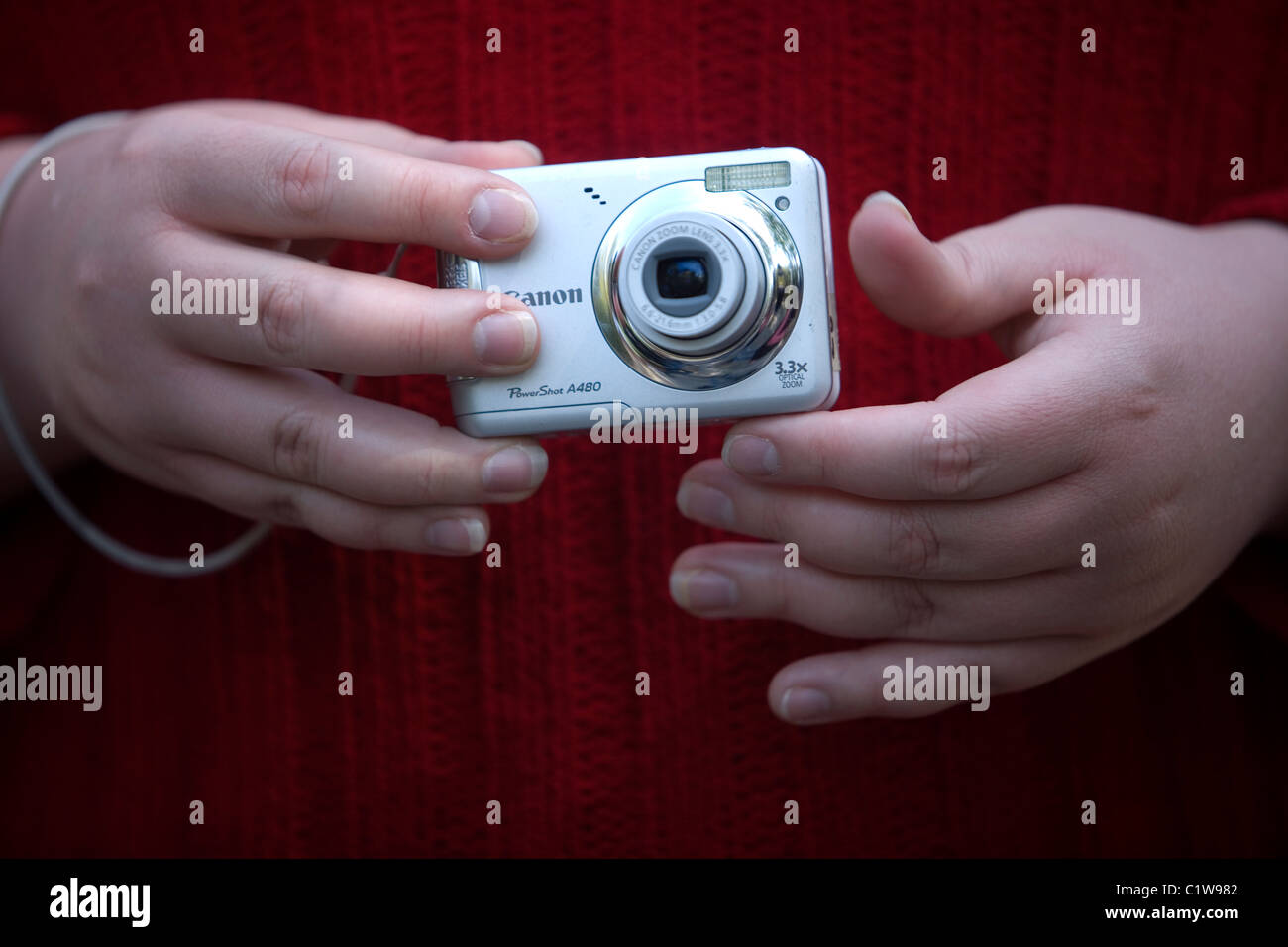 A blind female student touches a camera during a photography workshop ...