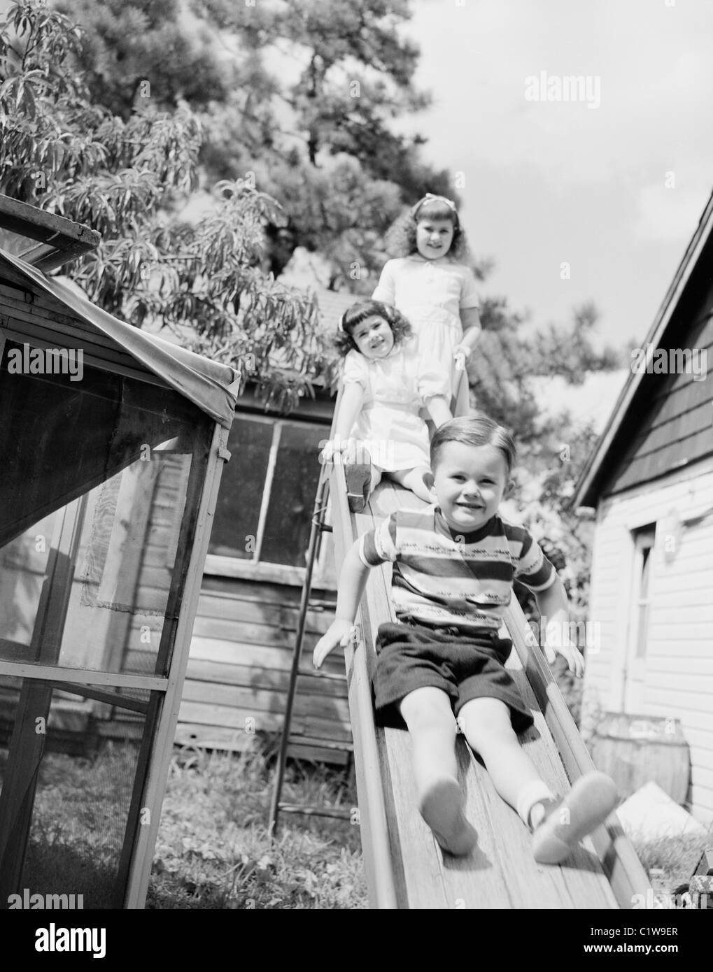 Children on slide Stock Photo - Alamy