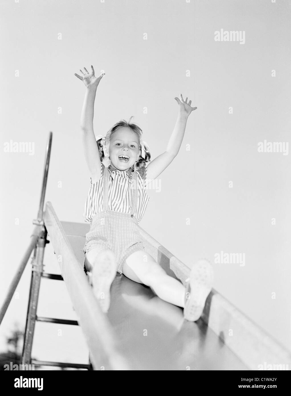 Girl on playground slide Black and White Stock Photos & Images - Alamy